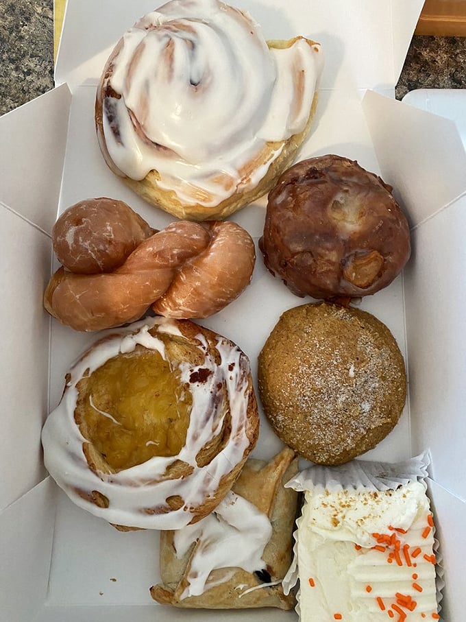 A box of joy containing the kind of donuts, pastries and cinnamon rolls that make nutritionists sigh and customers smile with zero regrets.