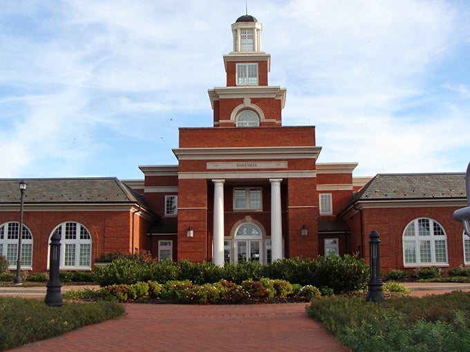 City Hall stands proud with its red brick and white columns, like a building that got dressed up for Sunday dinner and decided to stay that way.
