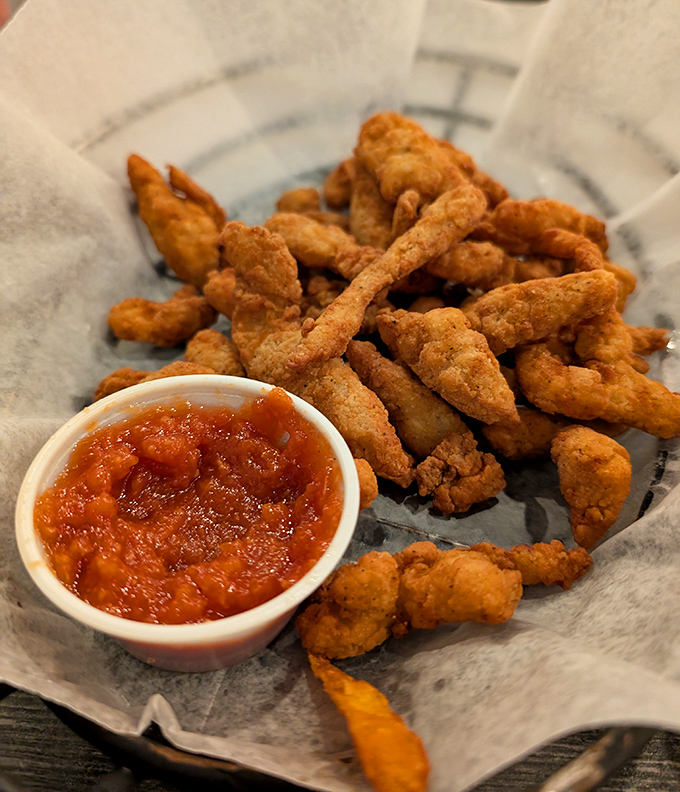 These golden-fried clam strips aren't just appetizers—they're little crunchy vessels of oceanic happiness, perfect for dipping and sharing.