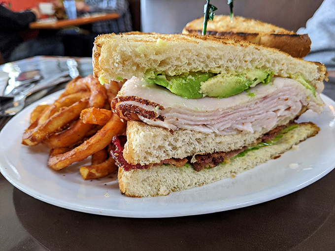 This club sandwich isn't just stacked—it's engineered for maximum flavor impact, with layers that tell a delicious story.