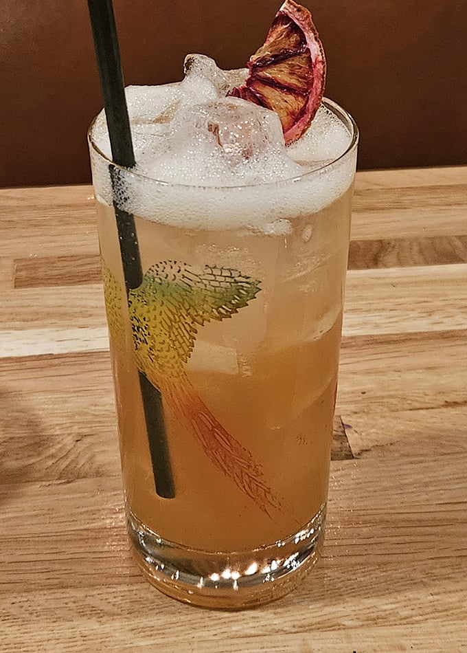 Not just a drink, but a work of art. This citrusy cocktail with charred fruit garnish is the liquid equivalent of a perfect sunset.