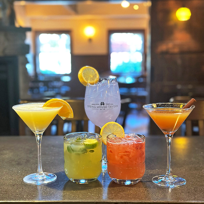 The cocktail lineup at Spring House looks like a liquid rainbow – each glass promising a different path to happiness.