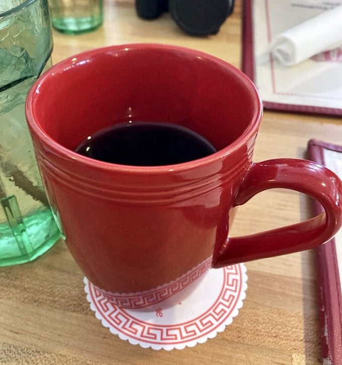 The humble red coffee mug—keeper of the elixir that powers mountain adventures. Bottomless refills here aren't just courtesy; they're practically law.