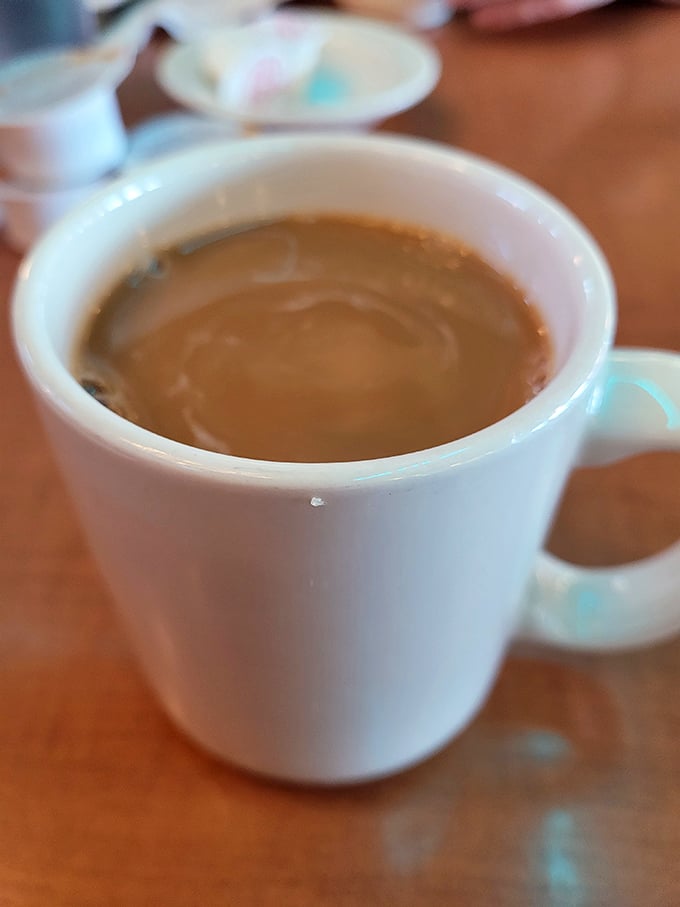 That classic white mug of diner coffee – not fancy, not pretentious, just honest brew that says, "Good morning, let's figure this day out together."