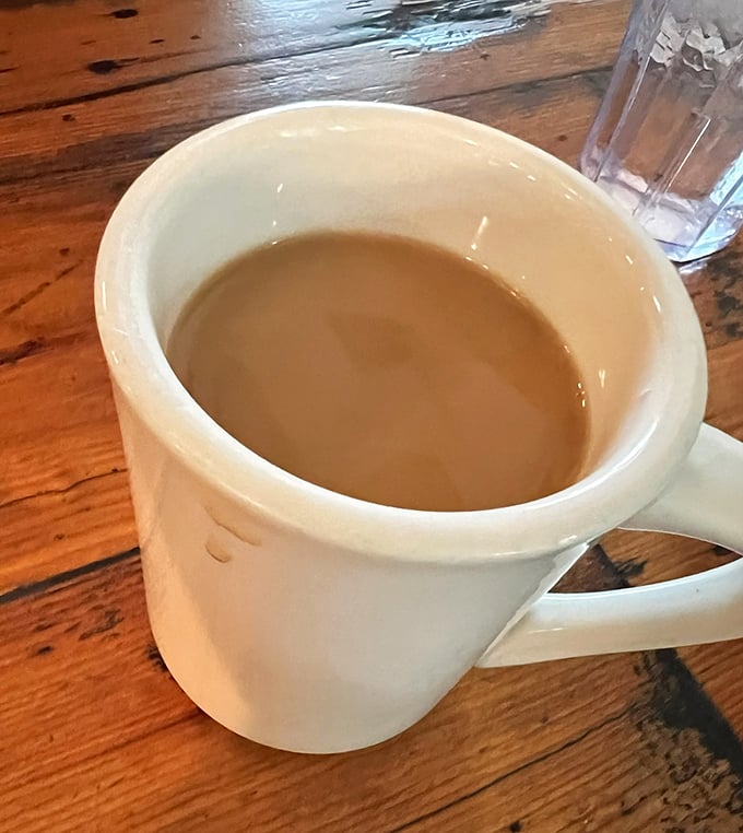 The humble diner coffee mug – steadfast companion to countless conversations and newspaper crosswords. No fancy latte art needed when the coffee's this good.