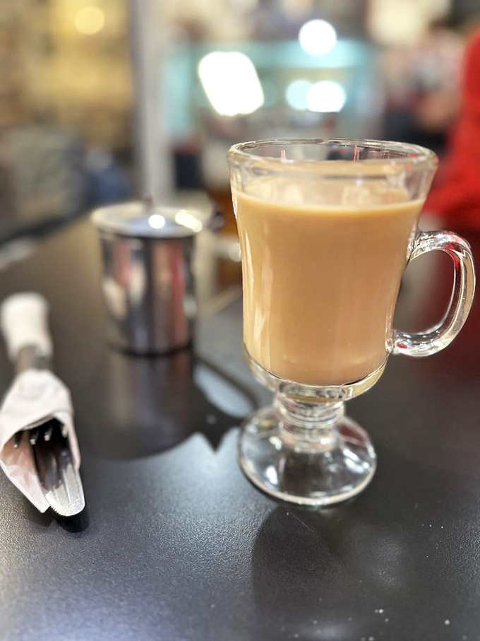 Coffee served in a proper glass mug—because some mornings require elegance. The perfect companion to that dream-worthy French toast.