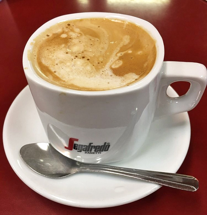 Coffee served in a proper ceramic cup—because some morning rituals deserve respect. Foam art optional, satisfaction guaranteed.