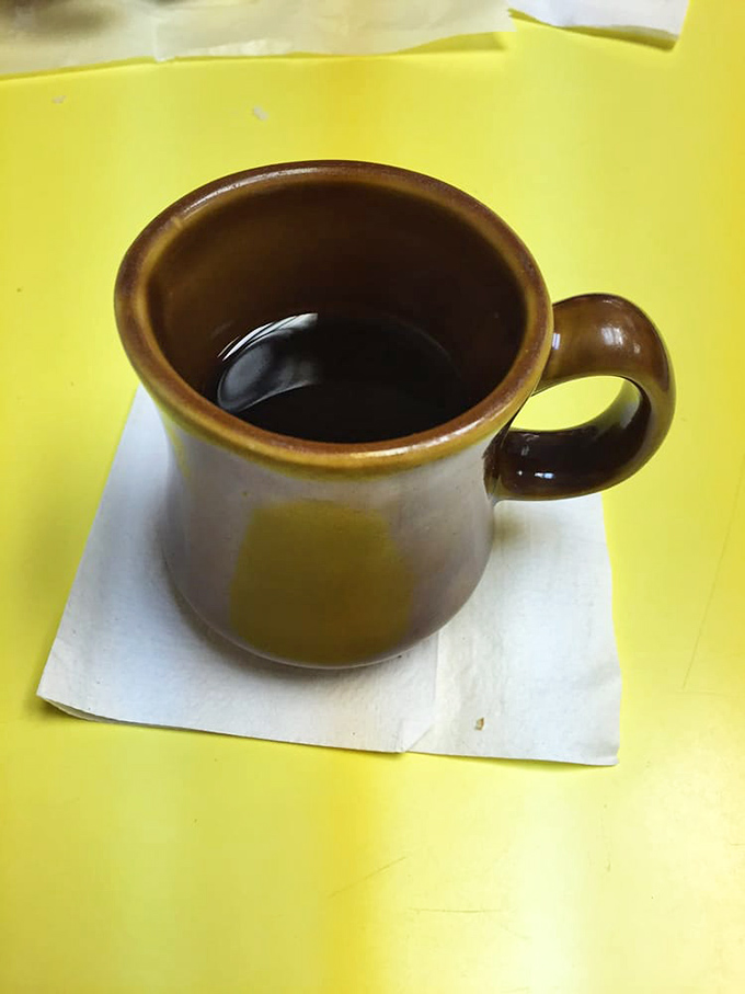 That sturdy brown mug isn't just holding coffee; it's holding the perfect companion for your donut adventure—simple, honest, and wonderfully old-school.