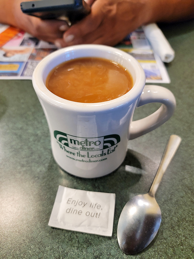 Coffee served with philosophy—"Enjoy life, dine out!" The mug practically whispers, "Take another sip and order those pancakes you're thinking about."