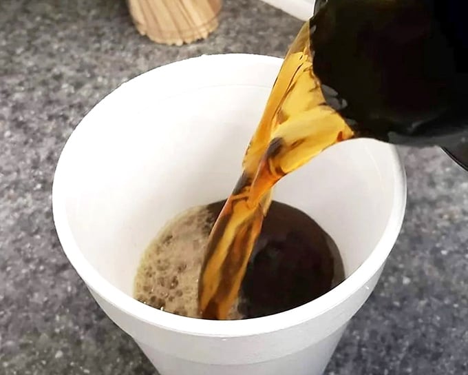 Coffee being poured with purpose – because even superheroes need sidekicks. The Robin to your donut's Batman.