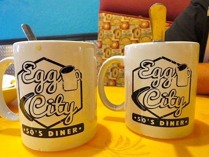 Those white mugs emblazoned with the Egg City logo aren't just vessels for coffee—they're chalices of morning salvation for the caffeine-deprived.