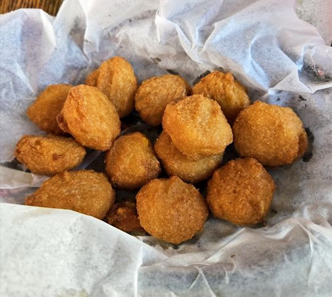 Hush puppies that don't just request silence—they demand it with their crispy exterior giving way to a tender cornmeal center worth contemplating.