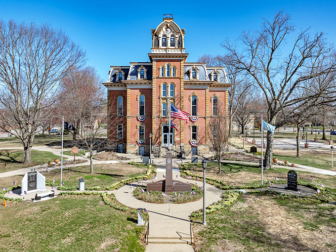 The Coshocton County Courthouse isn't just governing—it's posing for posterity with its Second Empire architecture and American flags.