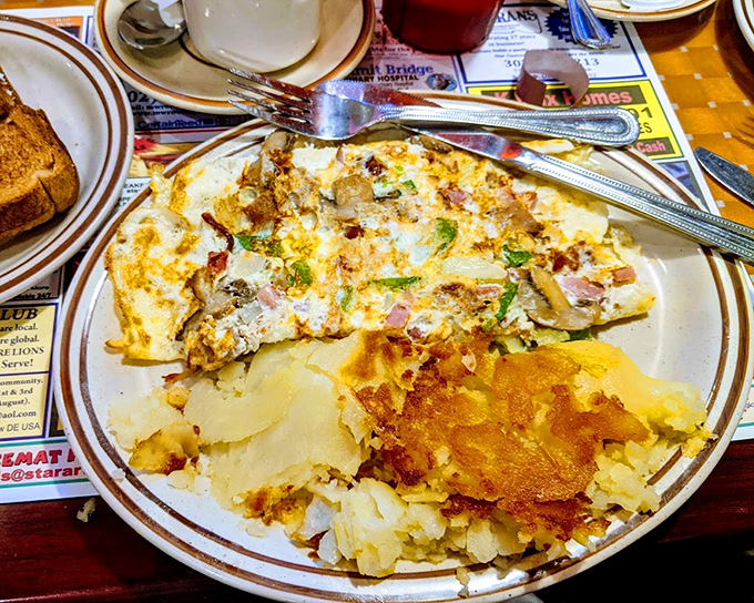 This isn't just an omelet – it's an edible treasure map where X marks the spot for every delicious ingredient hiding inside.
