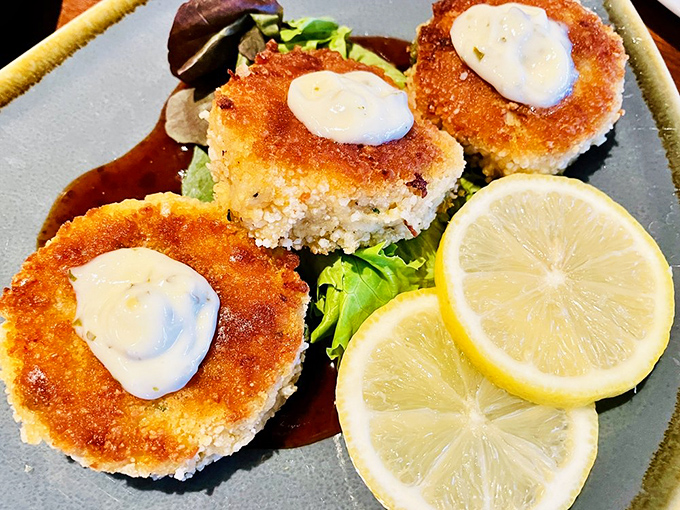 Crab cakes that actually taste like crab – revolutionary concept, perfectly executed with golden-brown confidence.