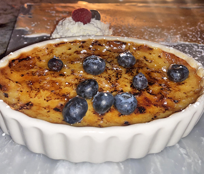 A crème brûlée that's achieved the perfect sugar-glass ceiling—tap it with your spoon and feel like the culinary equivalent of a safe-cracker.