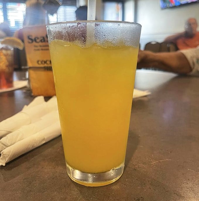 Orange crush in a frosty glass – because even seafood legends need the perfect liquid sidekick.