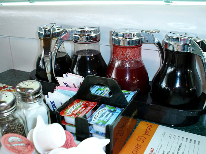 Syrup dispensers standing at attention like breakfast soldiers, ready to transform your pancakes from good to "I'm moving to Wisconsin."