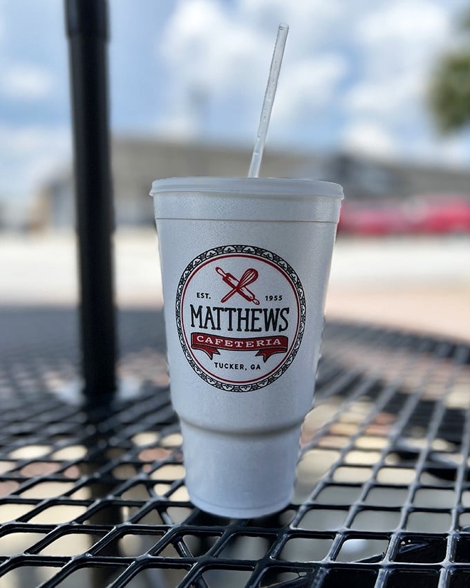 Sweet tea served in a cup bearing the Matthews logo—liquid Southern hospitality that'll keep you cool while simultaneously giving you a sugar rush.