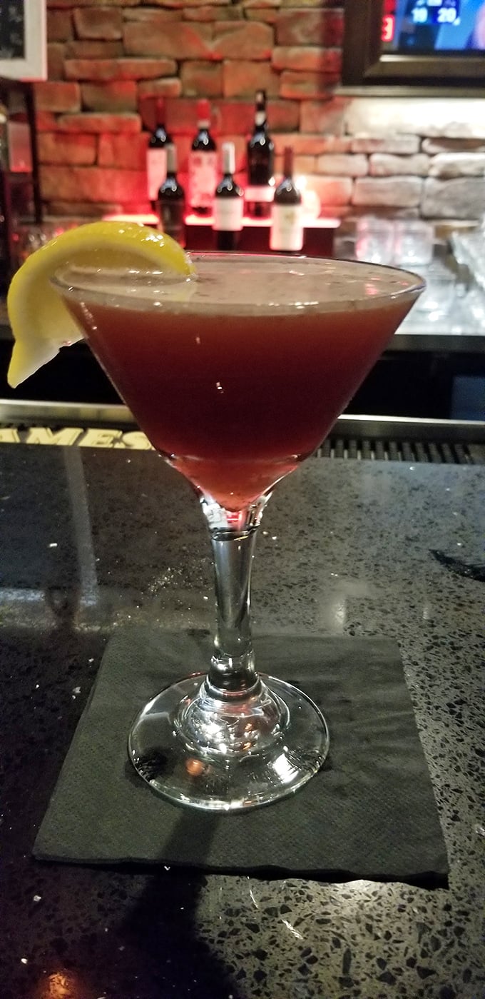A martini that's dressed better than most people at the opera, with a stone bar backdrop that screams "your problems can wait until tomorrow."