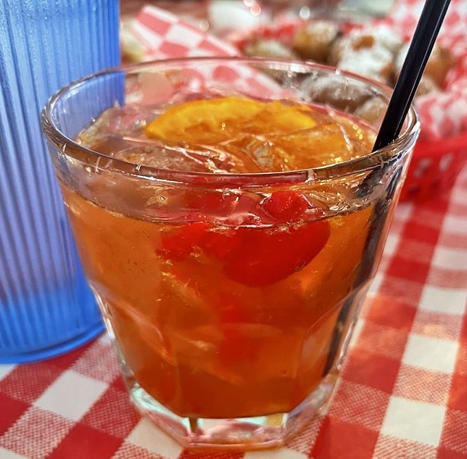 An old fashioned that doesn't need a mixologist with a waxed mustache to make it perfect – just honest pour in a proper glass on a checkered tablecloth.