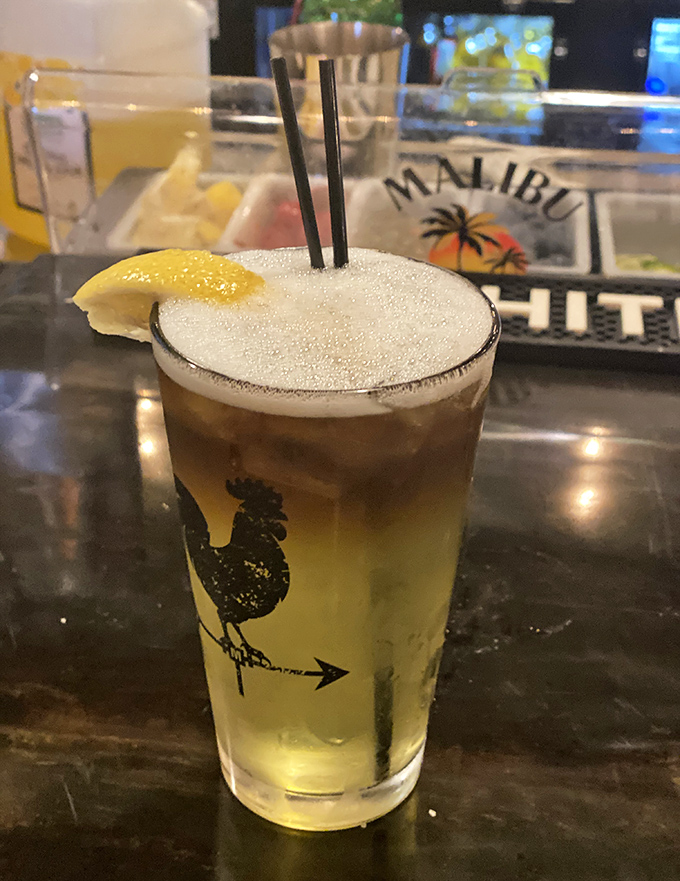 A perfectly crafted cocktail with a frothy top and citrus garnish—because sometimes the best appetizer comes in a glass.