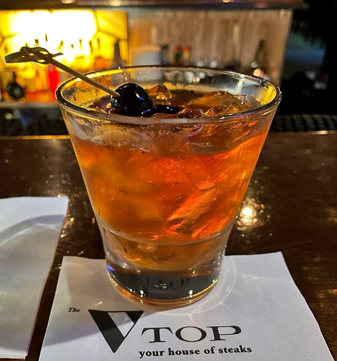 An Old Fashioned rests on The Top's napkin—liquid amber containing decades of cocktail craftsmanship and the promise of a memorable evening.