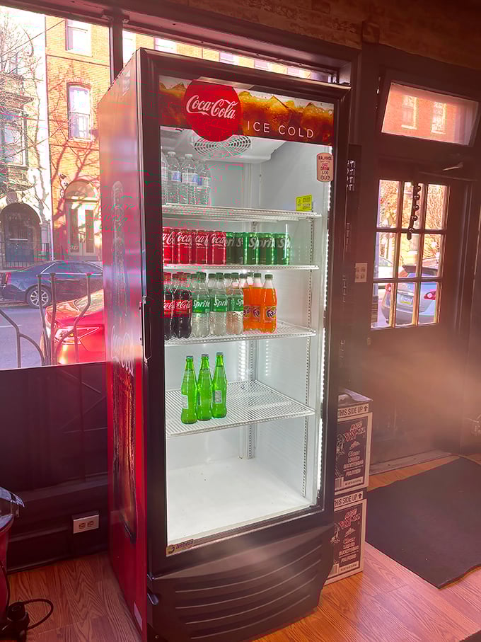 The beverage cooler stands ready, like a faithful companion waiting to extinguish the thirst that only great sandwiches can create.