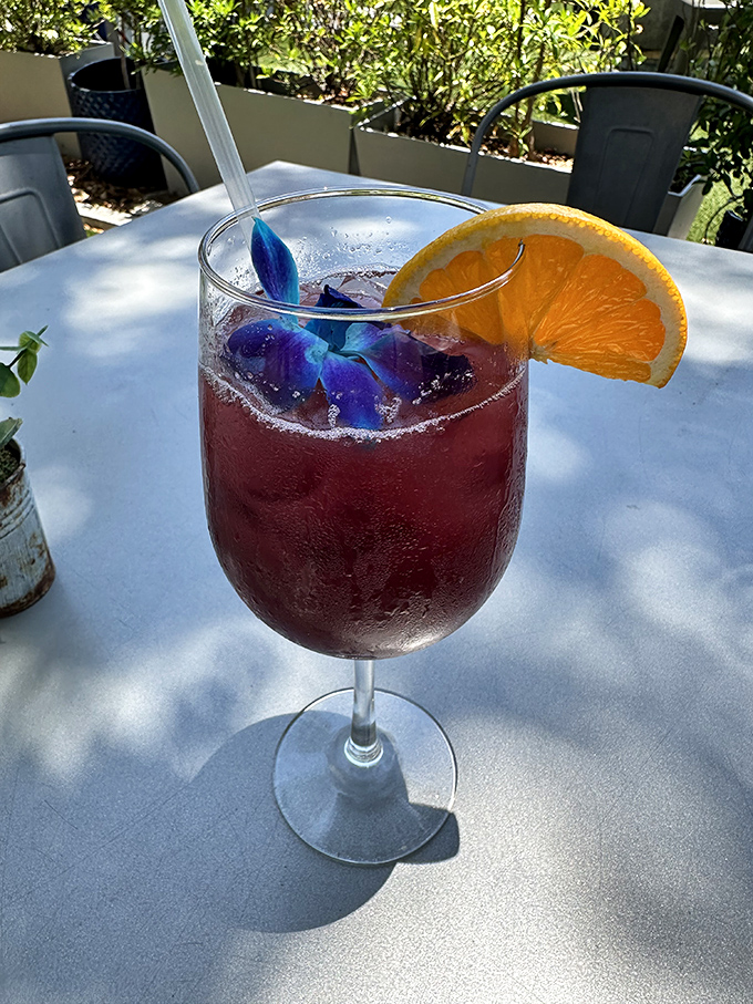 Sunshine in a glass! This vibrant cocktail with its edible flower garnish captures Florida's playful spirit – vacation in liquid form.