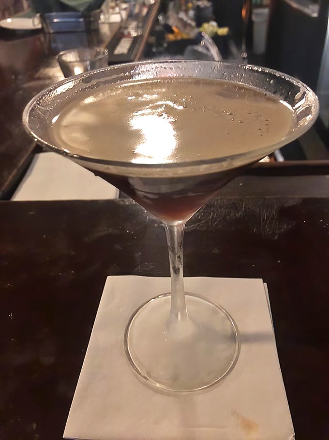 The martini glass isn't just holding a cocktail – it's cradling liquid sophistication that perfectly caps an evening of culinary indulgence.