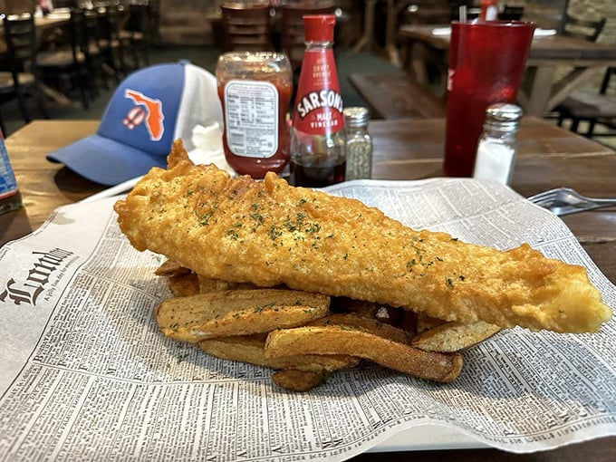 Fish and chips served on newspaper—a crispy golden reminder that sometimes the simplest foods are life's greatest pleasures.