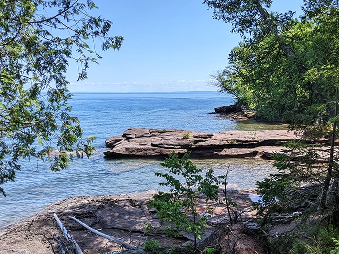 A hidden cove where the trees lean in to hear Lake Superior's secrets. The water clarity here makes you wonder if someone sneakily installed glass instead of actual lake.