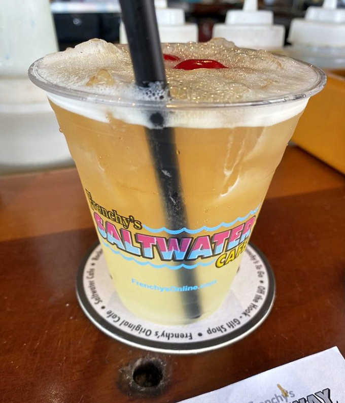 A proper Florida vacation in a glass: Frenchy's signature cocktail catching the afternoon light like liquid amber.