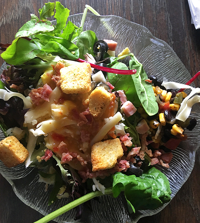 Fresh greens piled high with bacon and croutons – because salad should never feel like punishment for enjoying life.