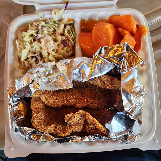 Catfish gets the royal treatment, wrapped in foil like the precious gift it is, with sides that refuse to be mere afterthoughts.