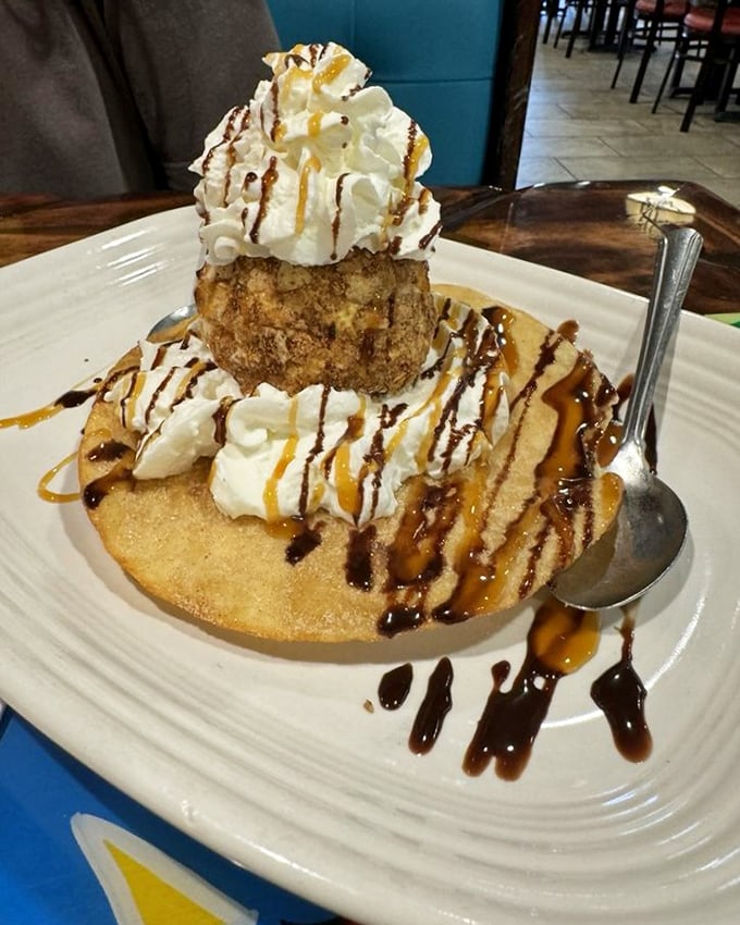 Fried ice cream that defies physics—hot, crispy exterior protecting cold, creamy interior. It's science and art on a plate, drizzled with chocolate and caramel.