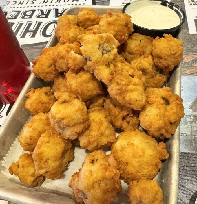 These golden-fried mushrooms aren't just appetizers—they're little flavor bombs waiting to explode. Paired with that dipping sauce, they're the opening act that threatens to upstage the headliner.