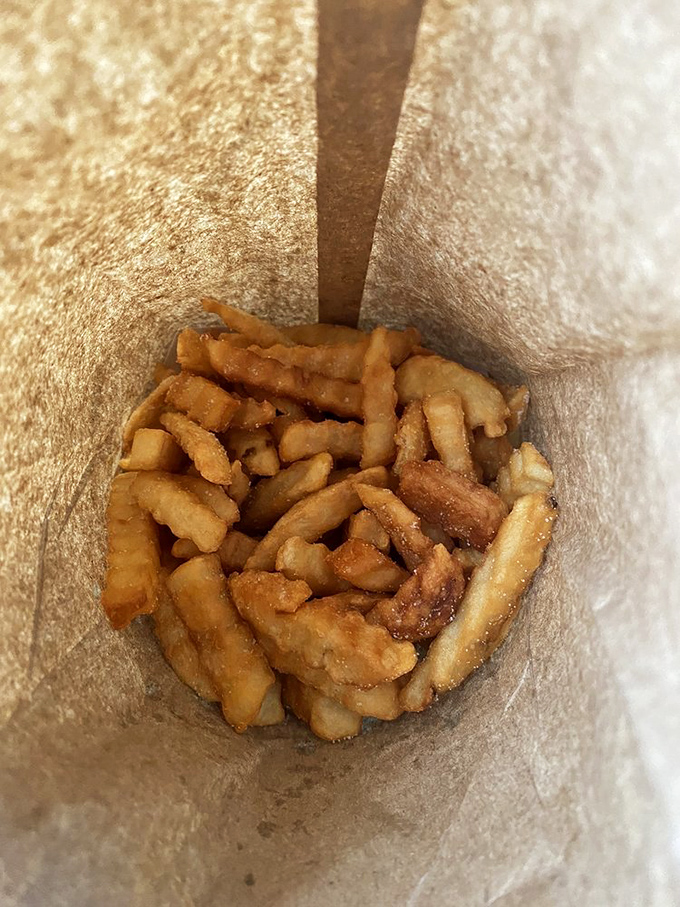 French fries done right—crispy, golden, and nestled in their paper bag like treasure. Simple pleasures are often the most satisfying.