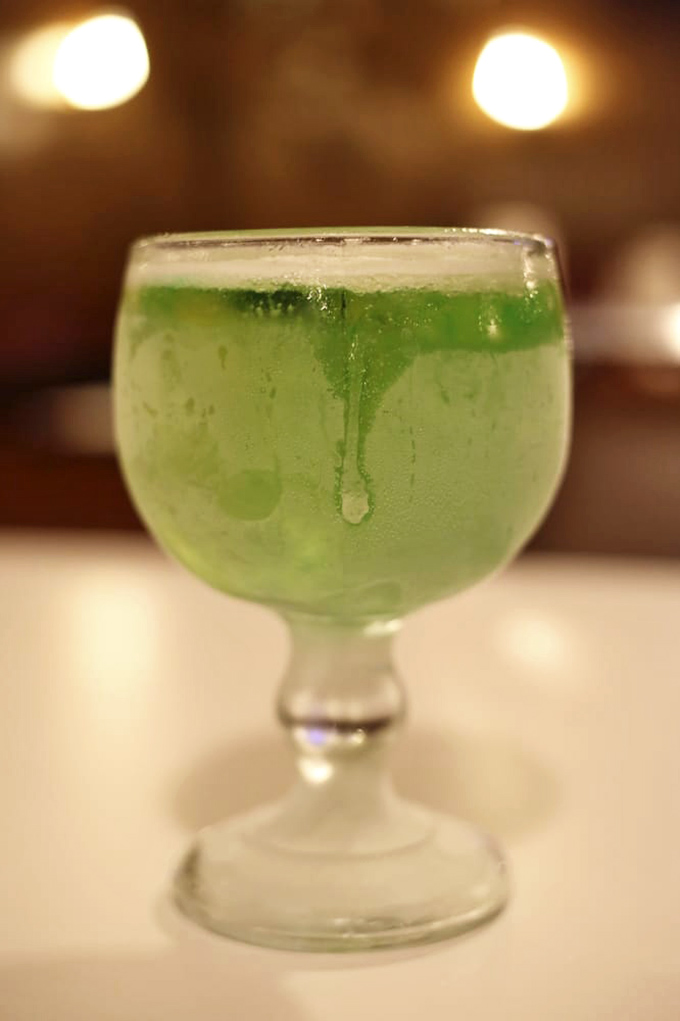 That's not just any green beer—it's a frosty goblet of refreshment that cuts through rich barbecue like a cold, emerald knight.