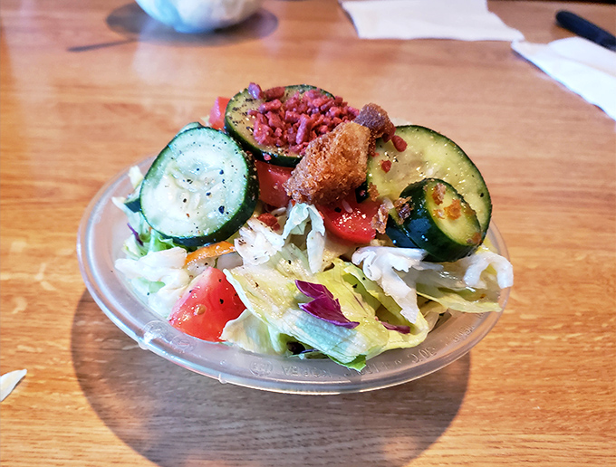 A salad bar creation that actually makes eating vegetables feel like less of a chore. Those cucumber slices are practically winking at you.