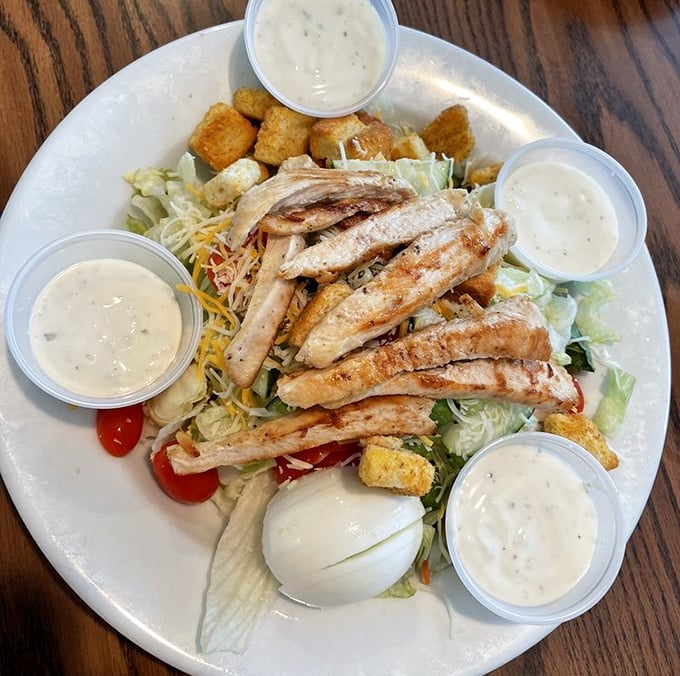 A salad so generous it makes other salads look like garnish. Those dressing cups aren't suggestions—they're an invitation to indulge.