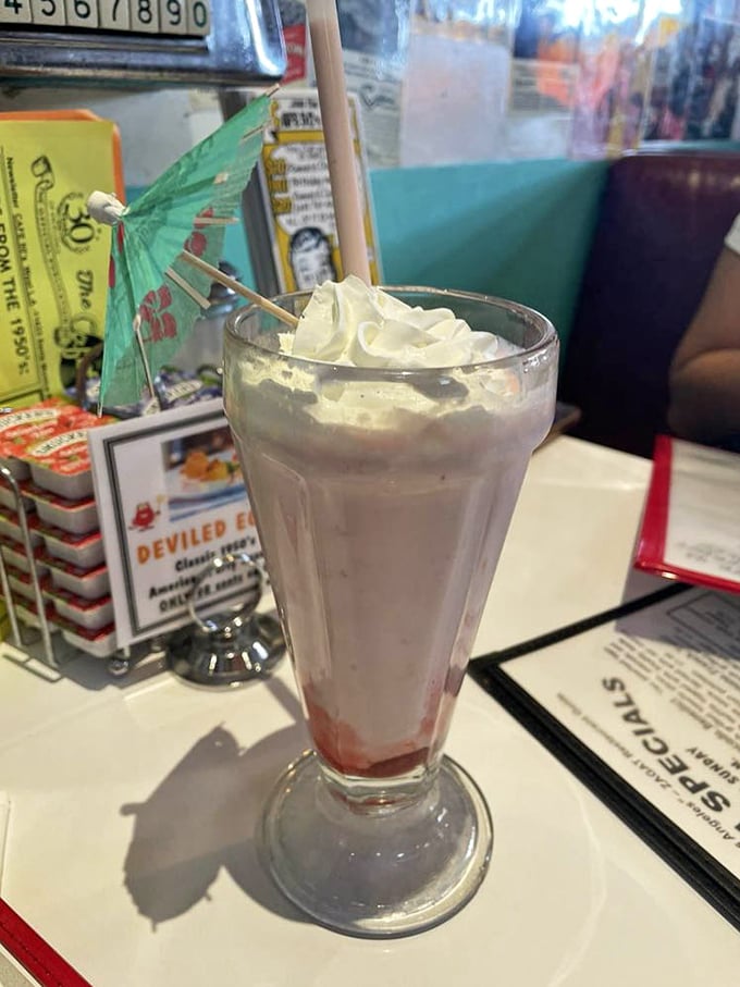 That little umbrella isn't just decoration—it's marking the spot where tropical vacation vibes meet classic diner indulgence in a frosty glass.