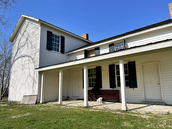 This historic white clapboard house tells stories of earlier times, when porches weren't just architectural features but essential social gathering spots.