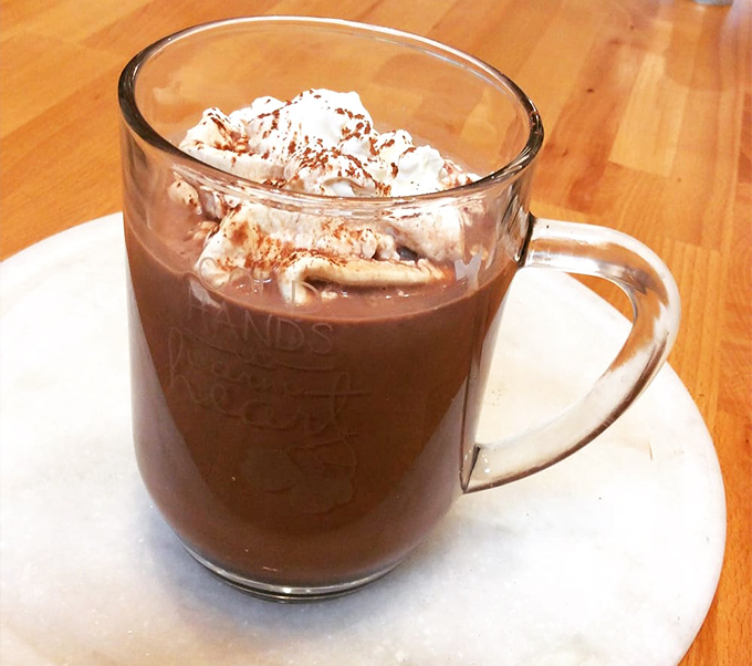 This isn't just hot chocolate—it's liquid comfort topped with a pillowy cloud of whipped cream that makes you wonder why anyone would ever drink the powdered stuff again.