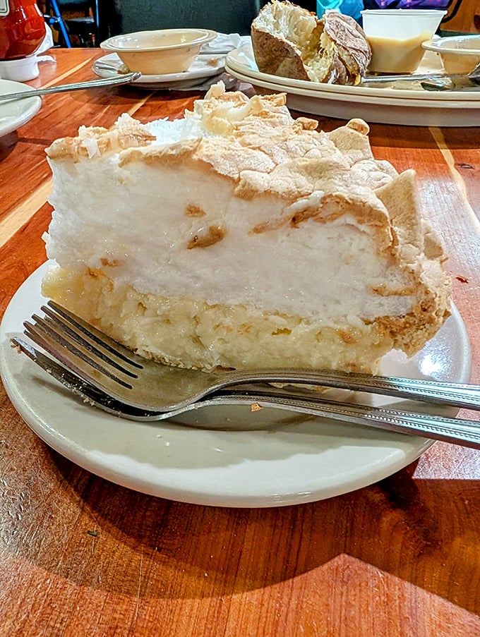 Mile-high meringue that defies both gravity and restraint. This isn't just pie; it's an engineering marvel with a sweet disposition.