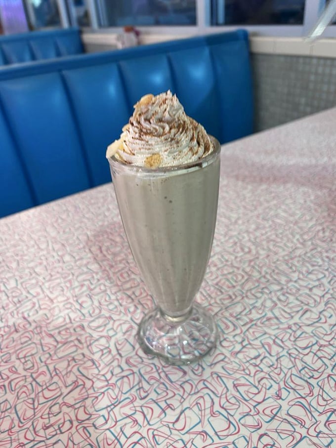 That milkshake isn't just thick—it's contemplating a career as soft-serve. The perfect companion for people-watching through those big diner windows.