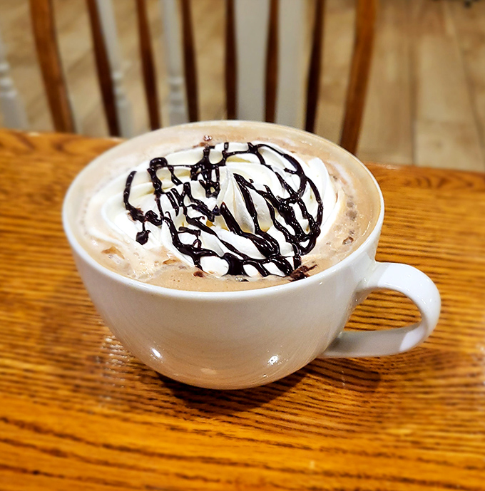 Hot chocolate that doesn't just warm your hands but hugs your soul—complete with a chocolate drizzle signature that says "You deserve this."
