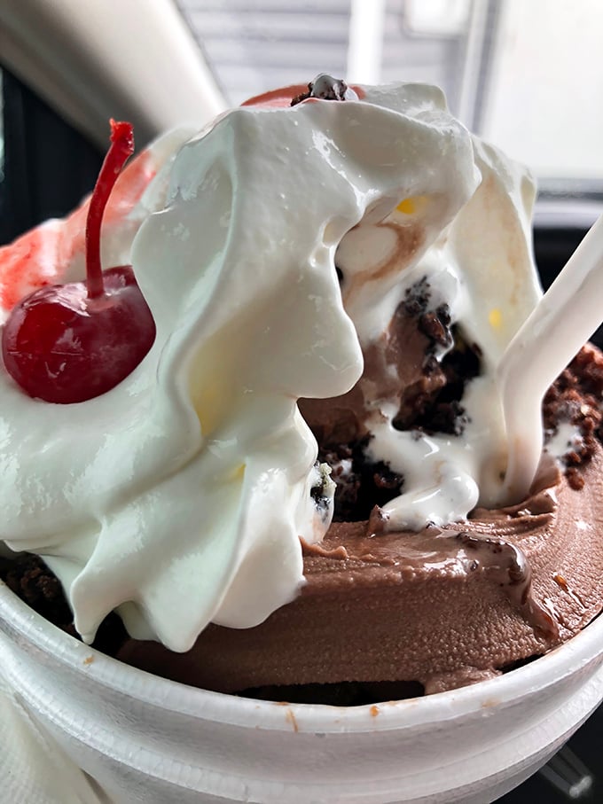 The hot fudge brownie sundae that makes diets cry uncle—where warm chocolate meets cold ice cream in a romance that's outlasted most Hollywood marriages.