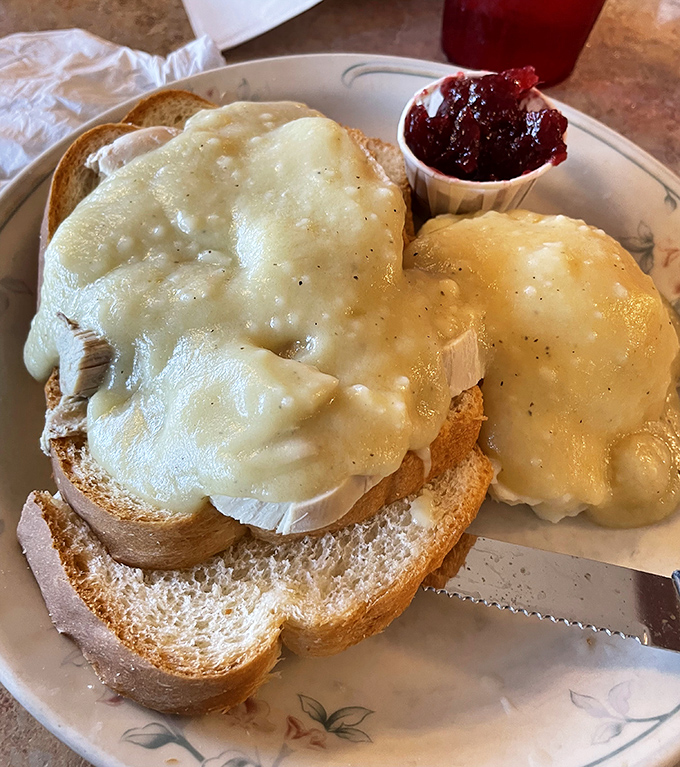 Open-faced hot turkey sandwich – comfort food architecture at its finest, where melted cheese creates a golden canopy over toasted bread.