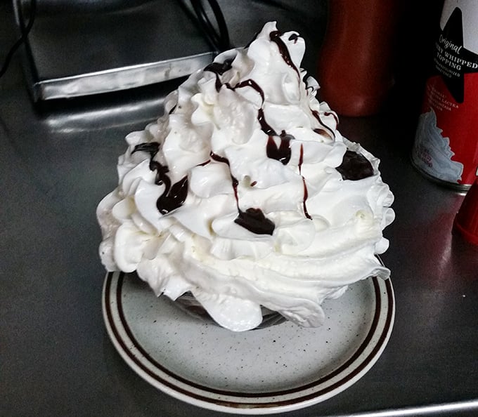 A mountain of whipped cream drizzled with chocolate – because sometimes dessert should look like a delicious snow-capped peak.